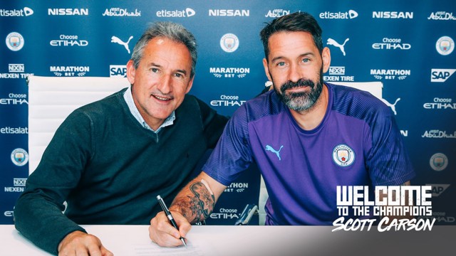 Scott Carson signs